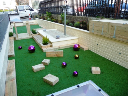 The finished play area, complete with bridge, planters, raised deck ...